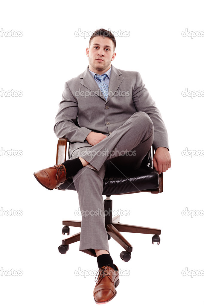 Confident businessman sitting on chair Stock Photo by ©Xalanx 38044875