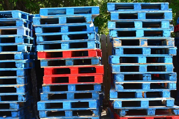 Piled blue wooden euro pallets background pattern Stock Photo by ...