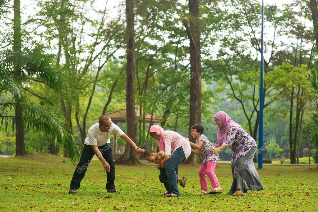 Muslim family having fun at outdoor — Stock Photo © szefei #27030661