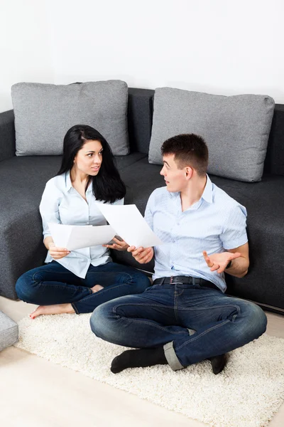 Unhappy couple reading a letter in the living room Stock Photo by ...