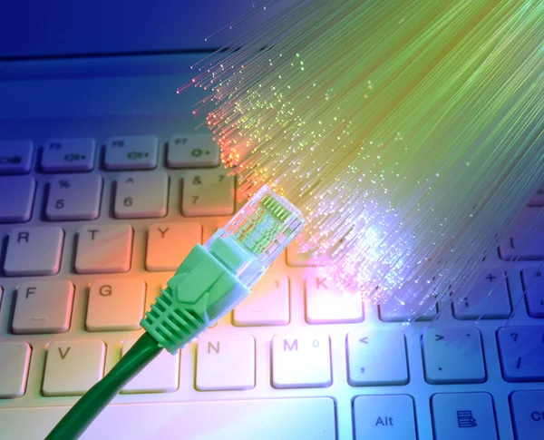 Network cable closeup with fiber optical background - Stock Image ...