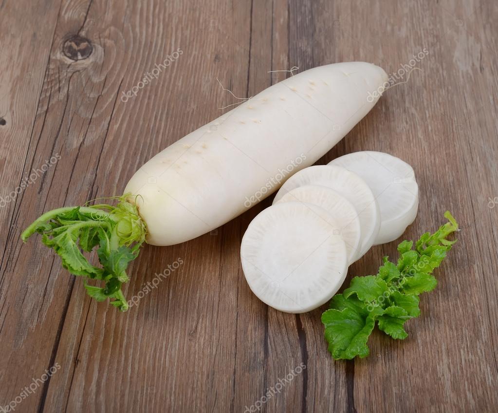 Daikon radish on the wood background — Stock Photo © firefox #47276867