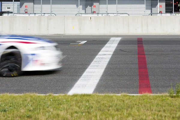 Race car driving fast around corner — Stock Photo © Corepics #125218666