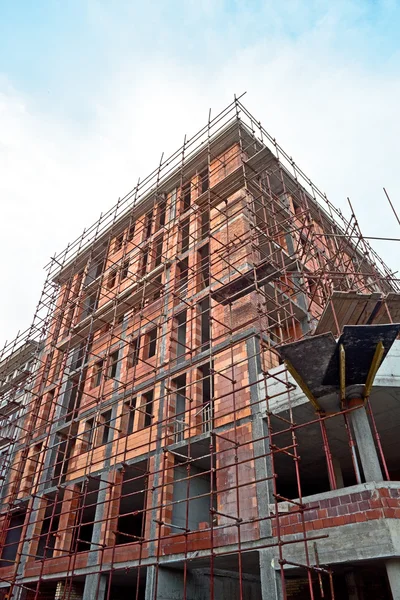 Scaffolding around new unrendered building at construction site Stock ...