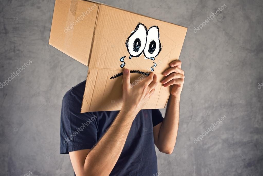 Man with cardboard box on his head and sad face expression — Stock ...