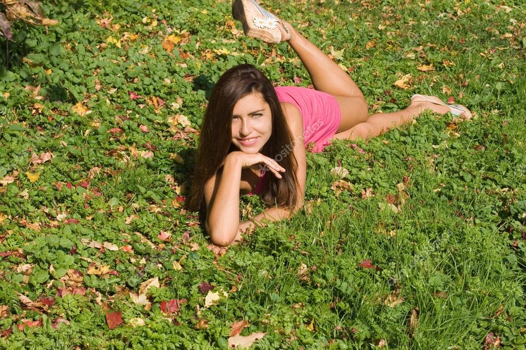 Girl resting on grass in autumn park — Stock Photo © Zoreslava #13644489
