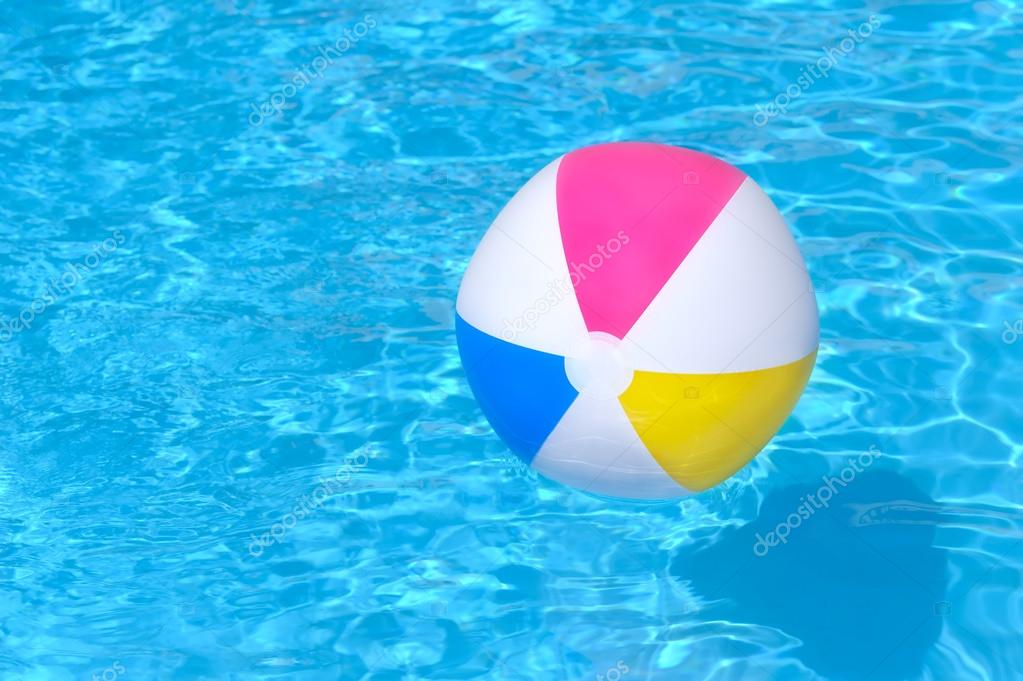 Inflatable ball floating in swimming pool Stock Photo by ©pajche 21402991