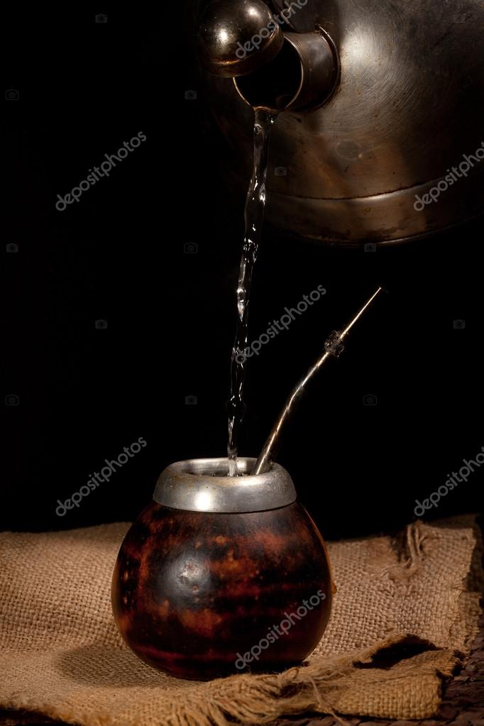 Pouring water from kettle into the calabash — Stock Photo © amuzica ...