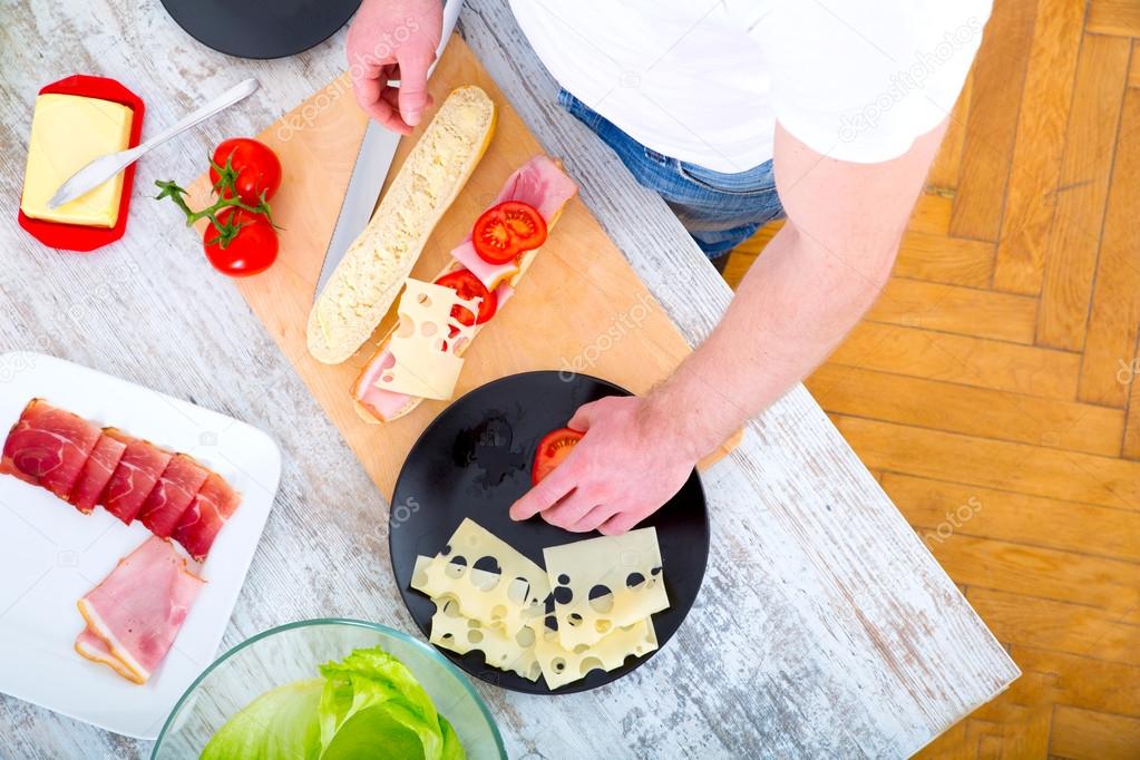 Young man preparing a Sandwich Stock Photo by ©Spectral 46761957