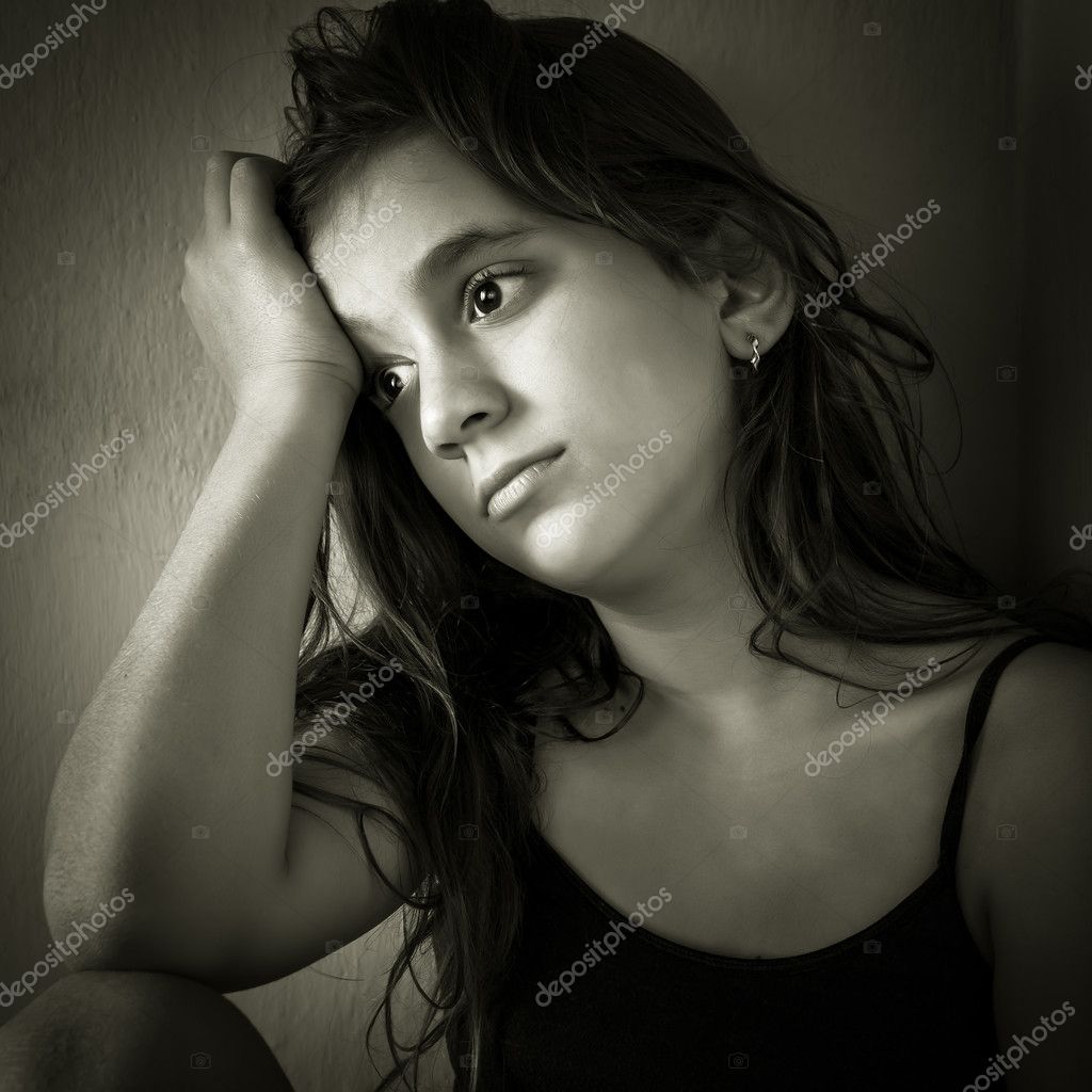Sad hispanic girl sitting in a corner — Stock Photo © kmiragaya #16501339