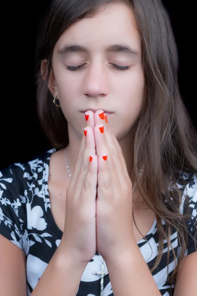 Hispanic girl praying isolated on black Stock Photo by ©kmiragaya 11600112