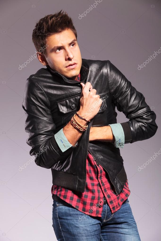 Handsome young man pulling his jacket on Stock Photo by ©feedough 15696565