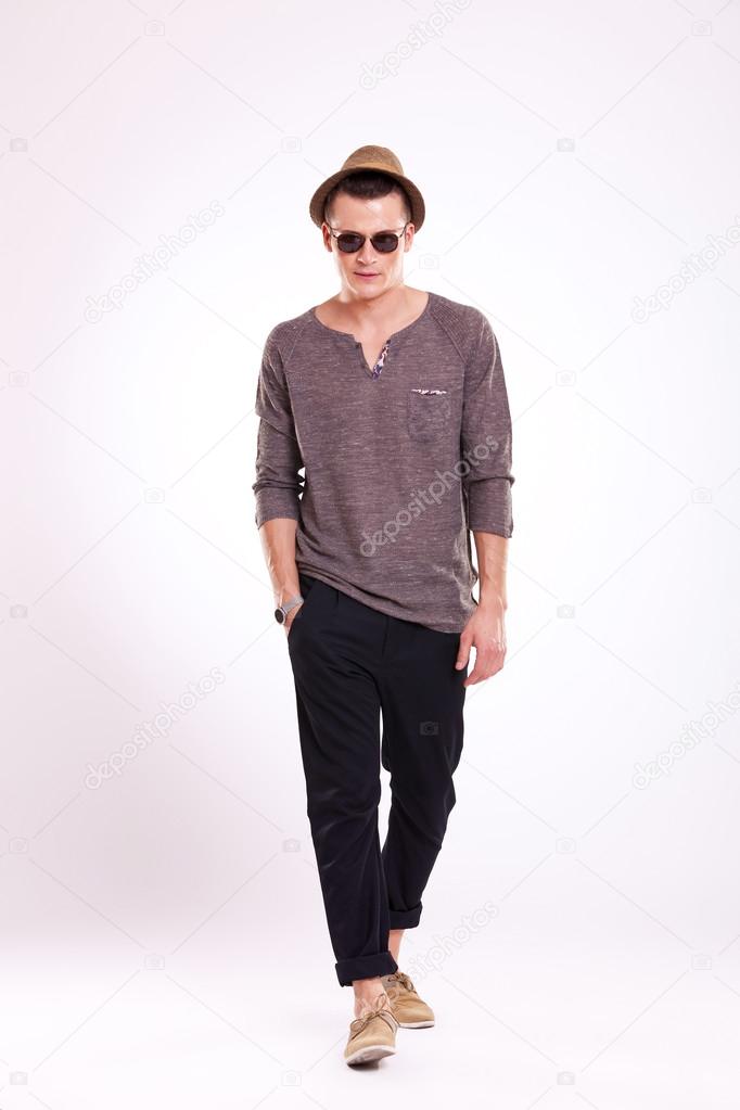 Cool young man walking forward Stock Photo by ©feedough 19117455