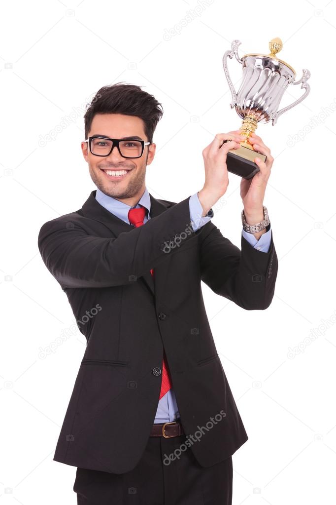 Raising his trophy & smiling Stock Photo by ©feedough 21172423