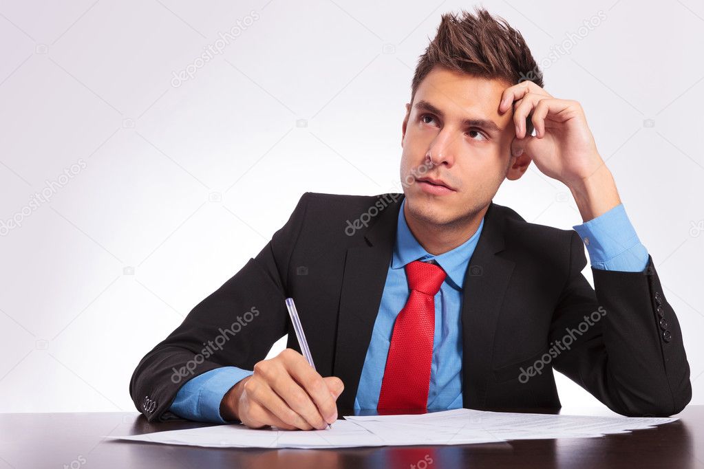 Man at desk thinking what to write Stock Photo by ©feedough 21172485