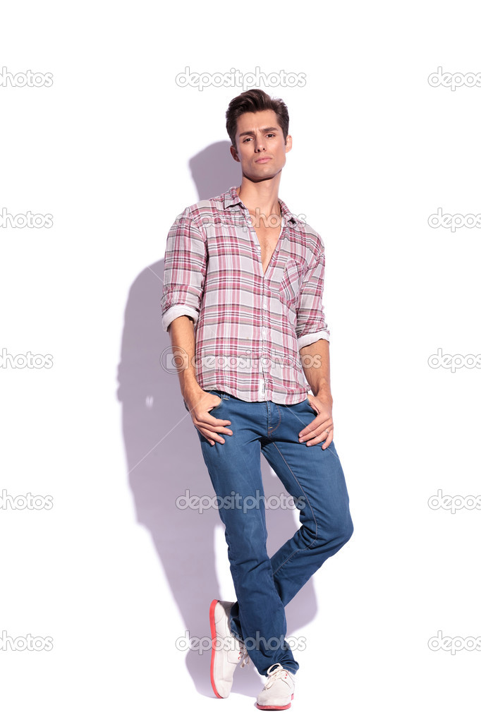 Serious man stands with legs crossed Stock Photo by ©feedough 23483045