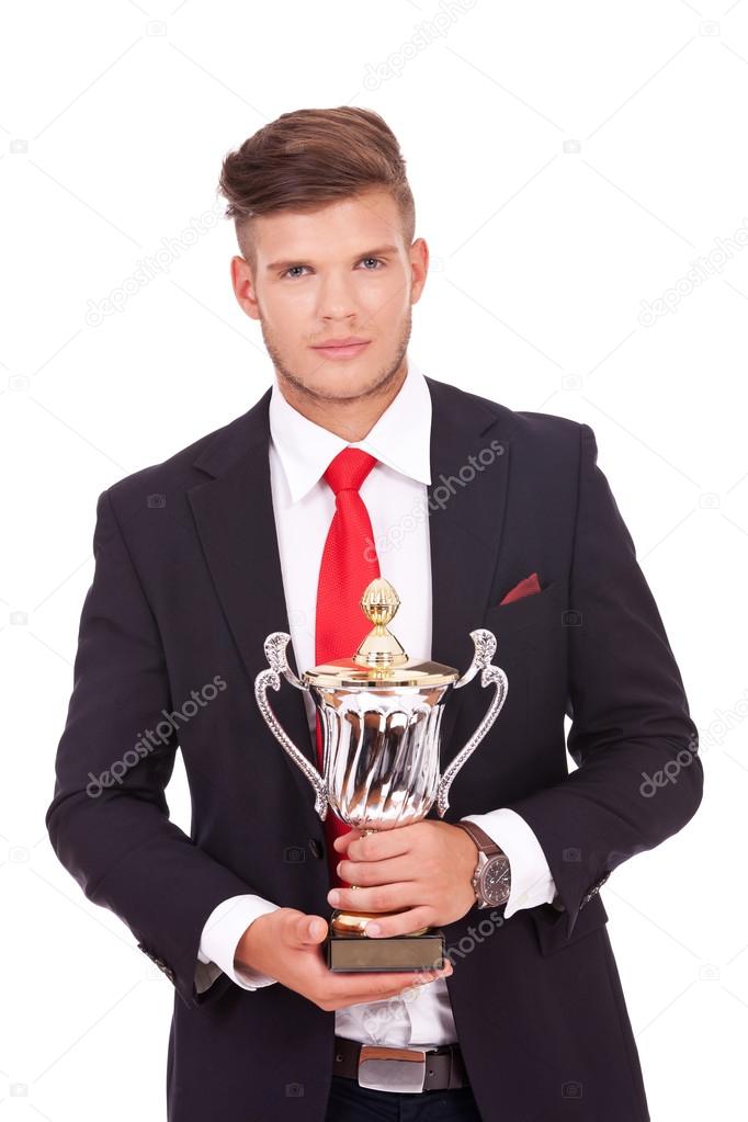 Business man holding trophy Stock Photo by ©feedough 24265383