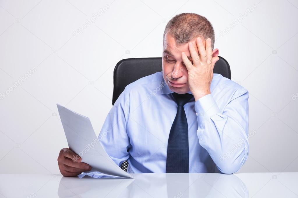 Old business man disappointed by reports — Stock Photo © feedough #26353071
