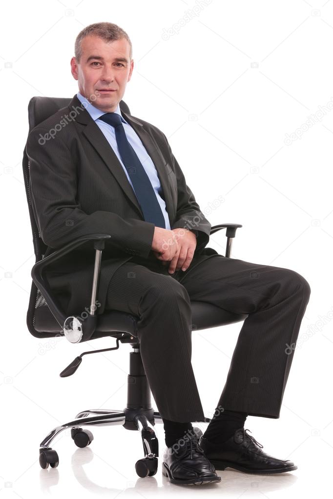 Business man sits on an office chair — Stock Photo © feedough #33873307