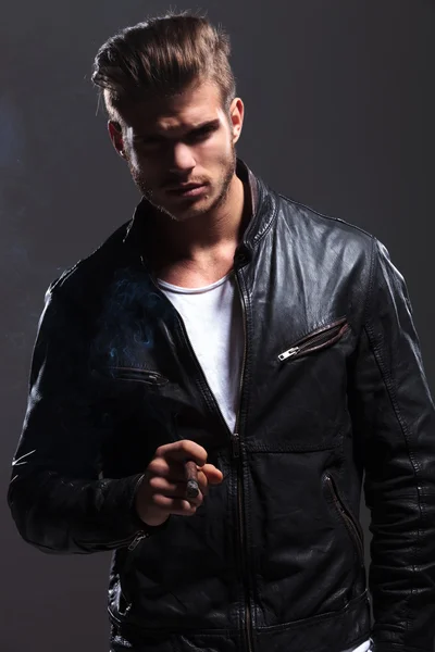 Fashion model in leather jacket with hands in his pockets Stock Photo ...