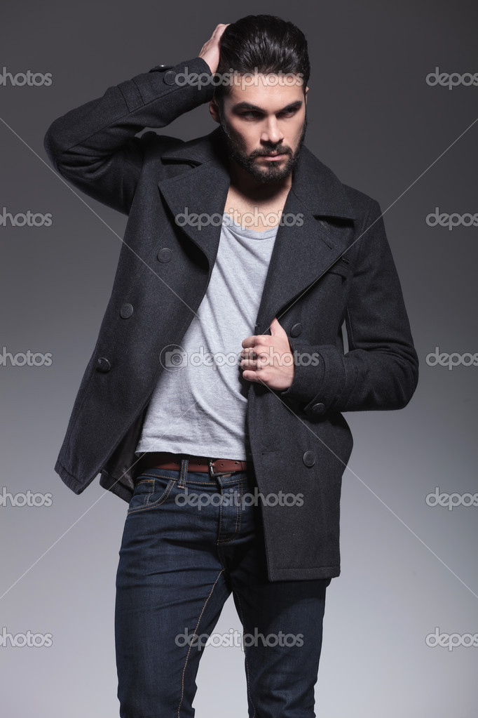 Young bearded man passing his hand through his hair — Stock Photo ...
