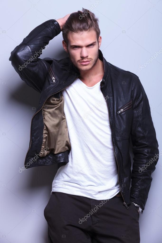 Man in leather jacket passing his hand thorugh his hair Stock Photo by ...