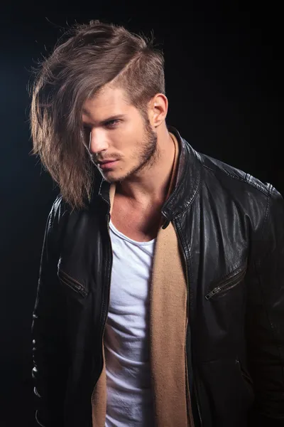 side view of a young fashion man in leather clothes - Stock Image ...