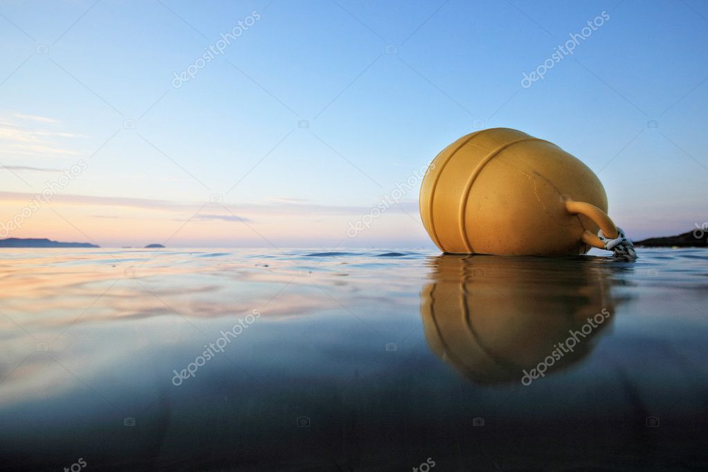 Buoy floating on the ocean waterline view Stock Photo by ©netfalls 12316071