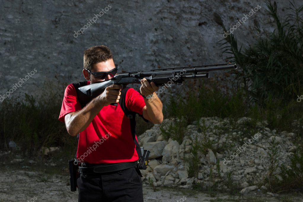 Man shooting on an outdoor shooting range Stock Photo by ©netfalls 16897637