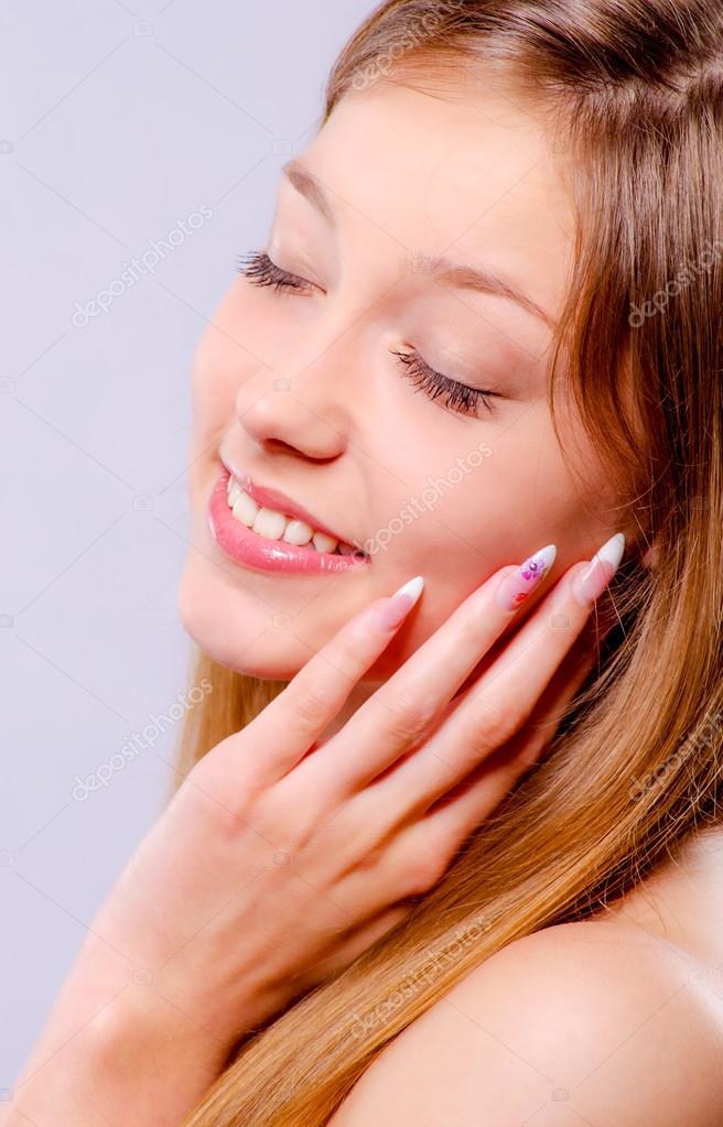 Beautiful girl with closed eyes touches her face Stock Photo by ...