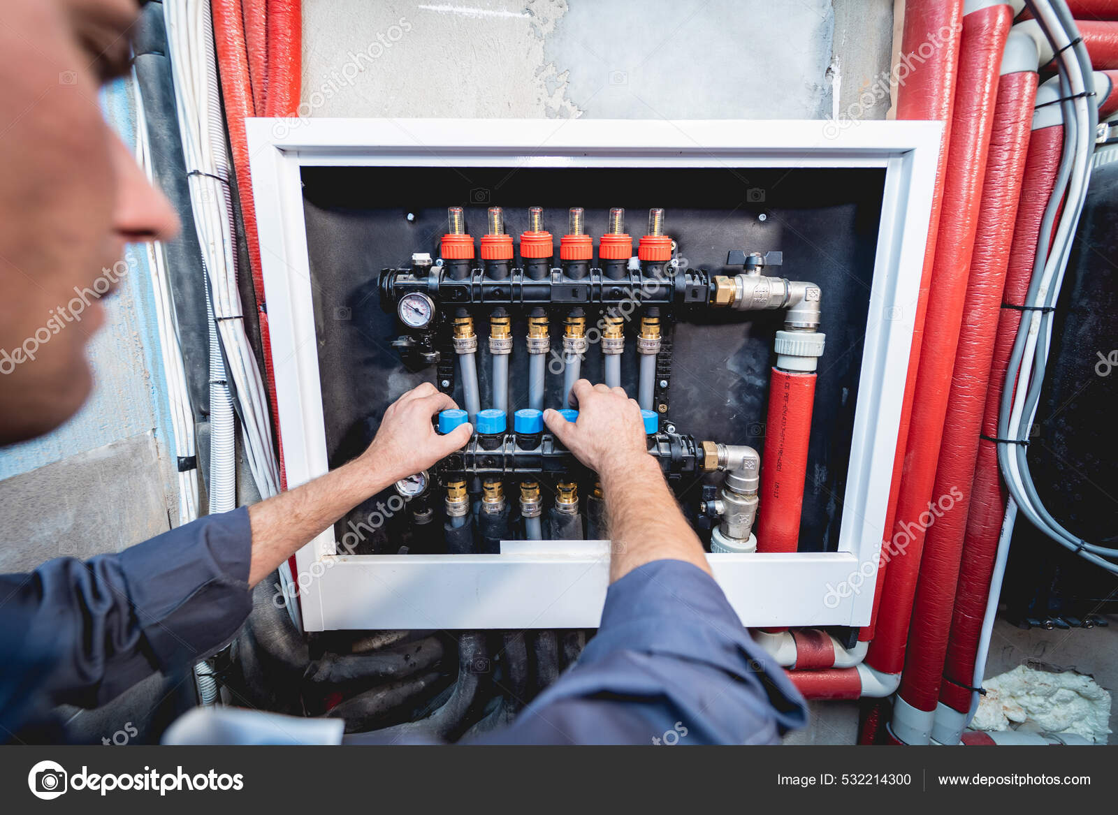 HVAC technician servicing home heating and cooling system Stock Photo ...