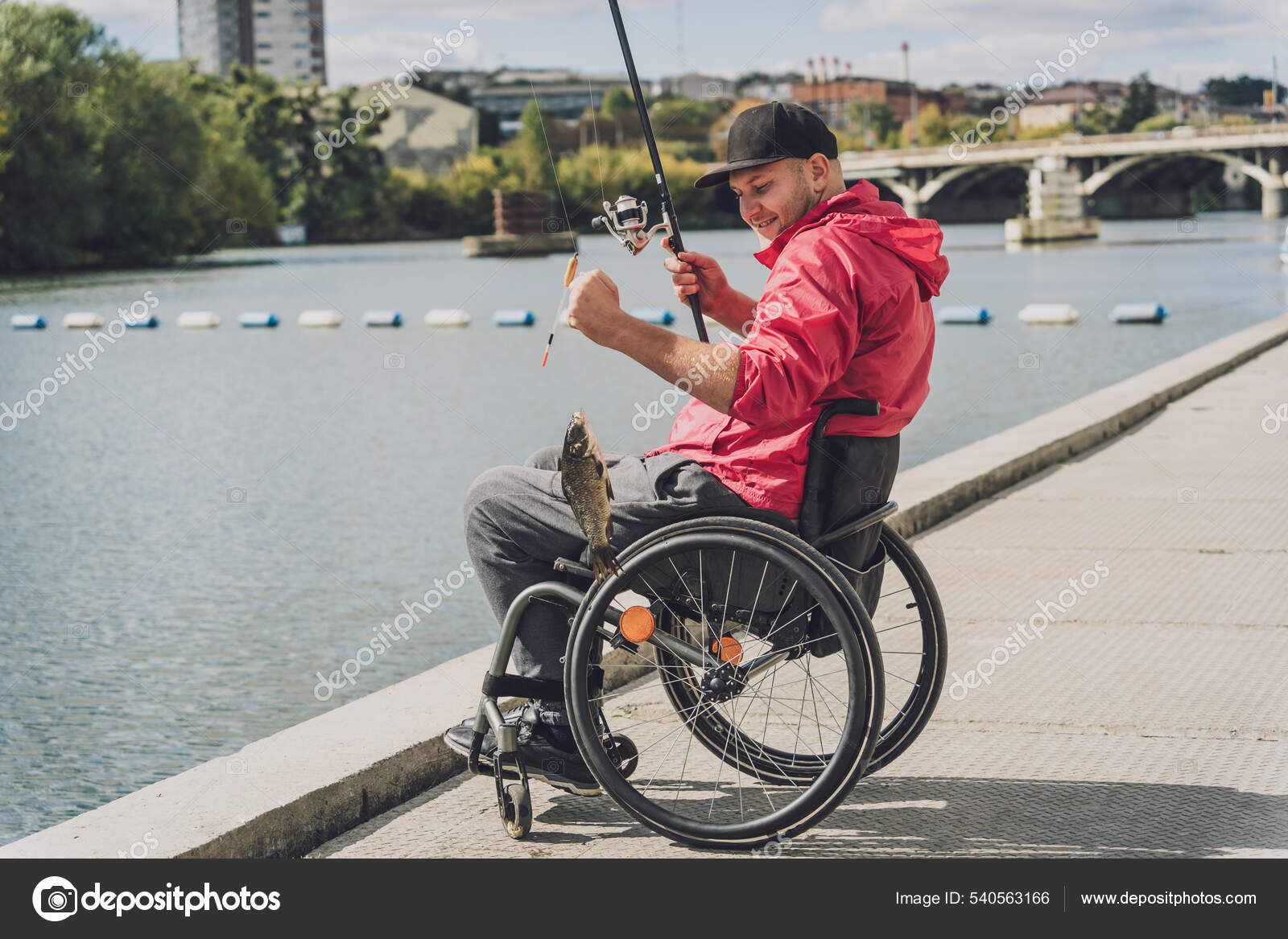 Person with a physical disability who uses wheelchair fishing from ...