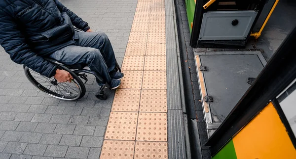 Person with a physical disability inside public transport with an ...