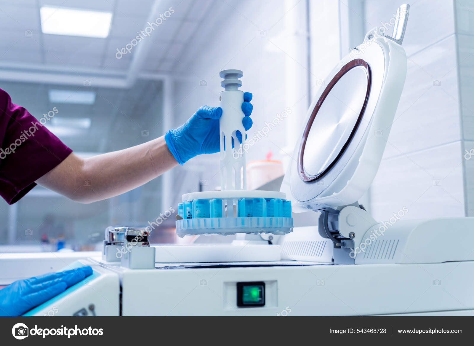 Laboratory assistant works with microwave hybrid tissue processor at ...