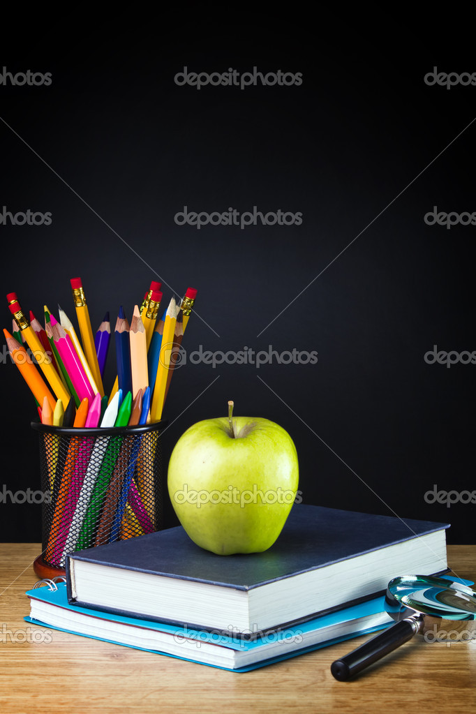 Teacher's desk with a color pencil, notebook and other equipment. Stock ...