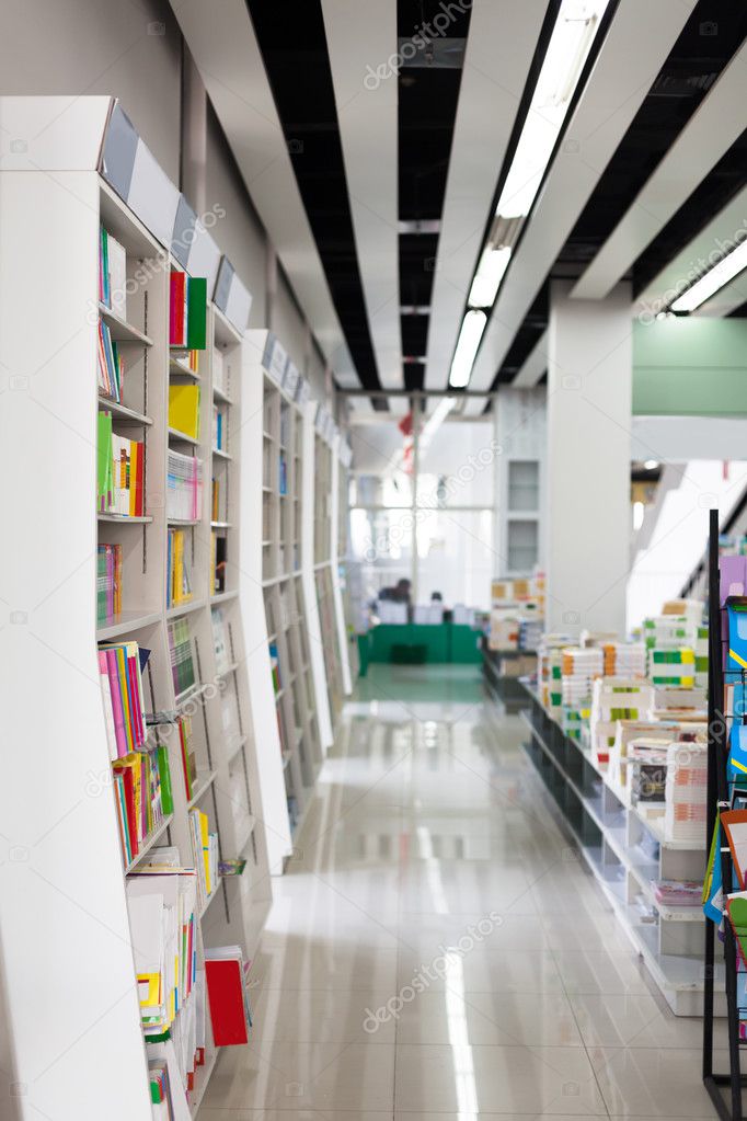 The aisles in a public library with shelves full of books — Stock Photo ...