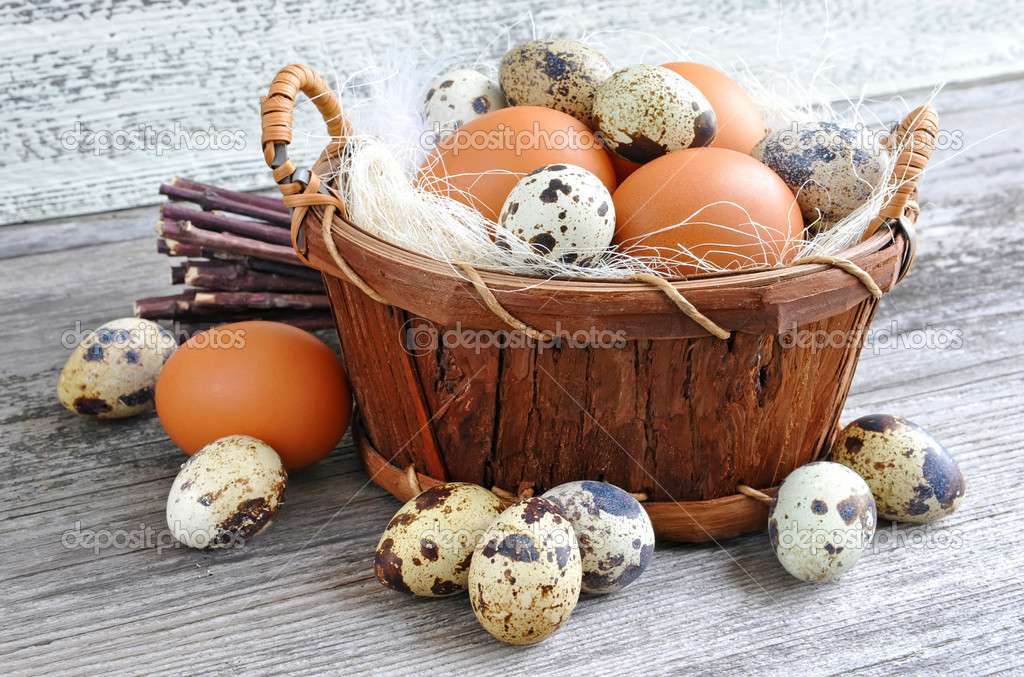 Different types of eggs in a basket on a old wooden background Stock ...