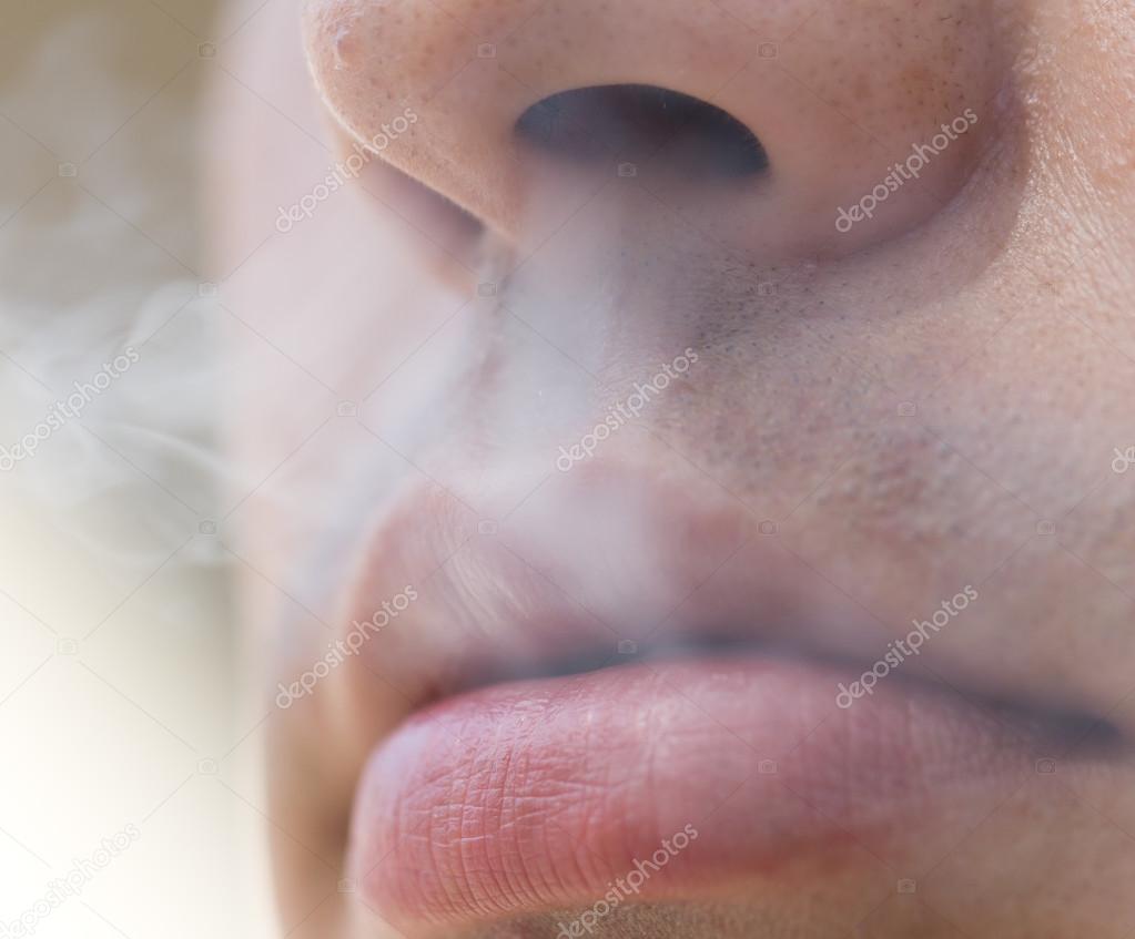 Cigarette smoke from the nose — Stock Photo © schankz #30834889