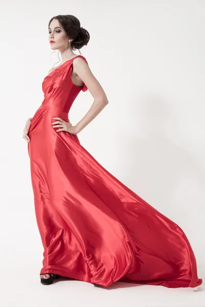 Young beauty woman in fluttering red dress. Stock Photo by ©yuriyzhuravov 35782855