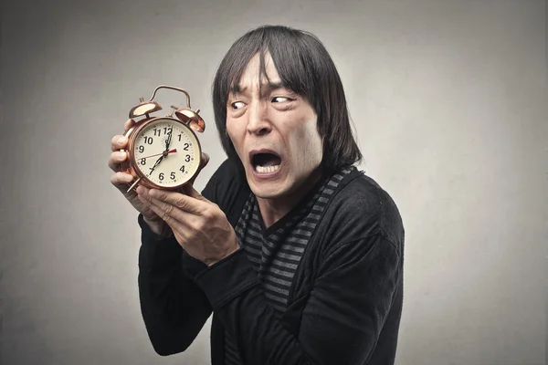 Surprised business man with alarm clock looking at smart phone — Stock ...