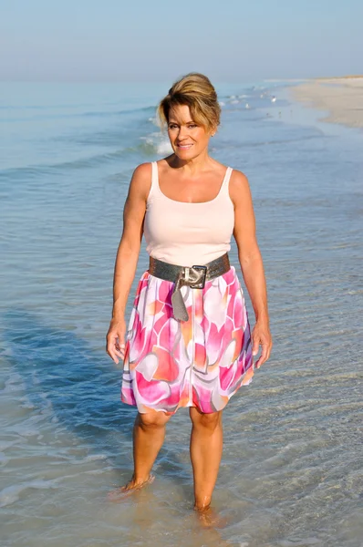 Attractive Woman Walking on the Beach Stock Photo by ©EyeMark 12627115