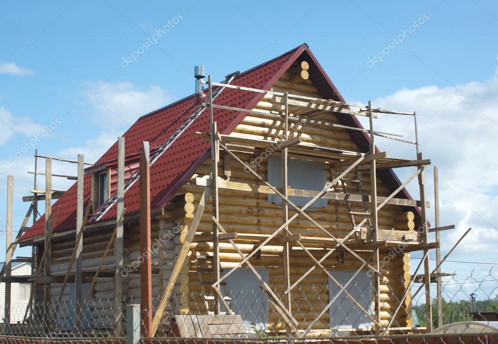 Wooden house construction in countryside — Stock Photo © iDyMax #12218305
