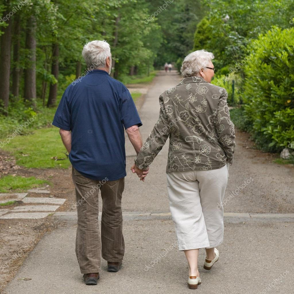 Old Couple Walking Hand In Hand