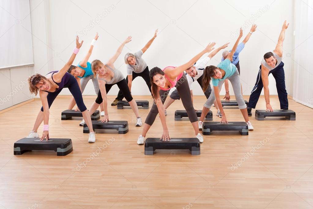Class doing aerobics balancing on boards — Stock Photo © AndreyPopov ...