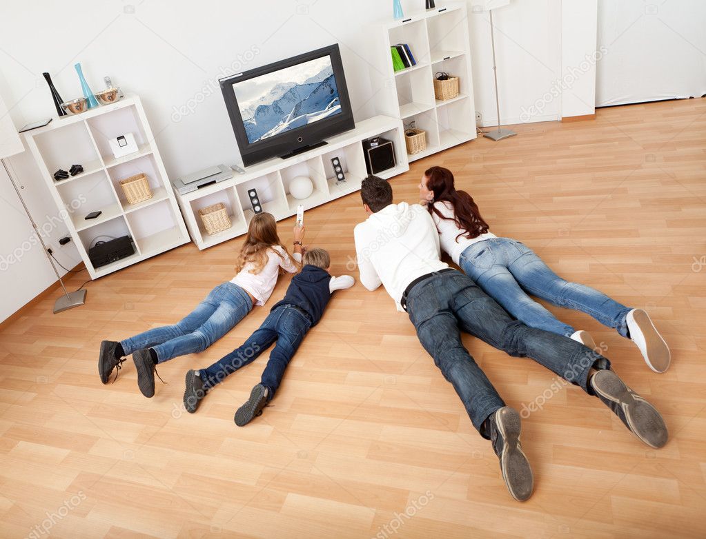 Young family watching TV at home — Stock Photo © AndreyPopov #19638215