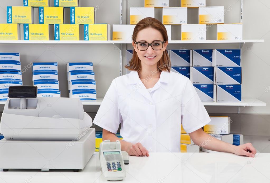 Female Pharmacist In Pharmacy — Stock Photo © AndreyPopov #27486807