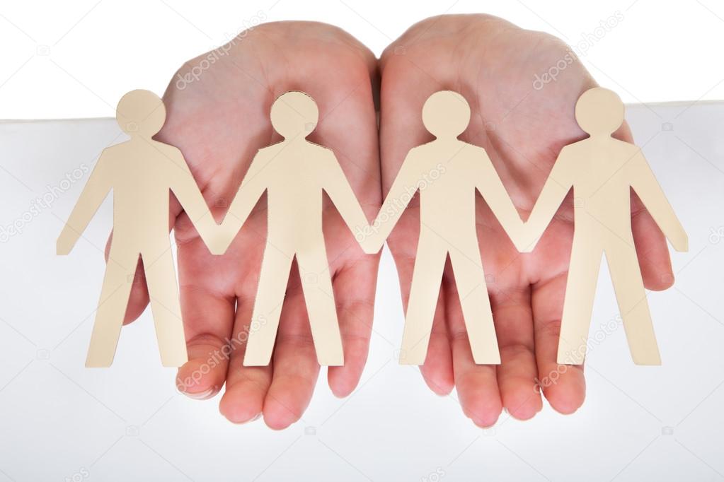 Male Hand Holding Human Figure Cutout Stock Photo by ©AndreyPopov 27663905