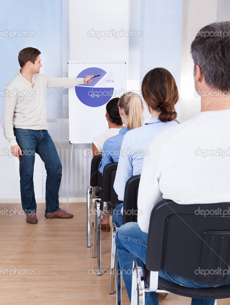 Joven hombre explicando gráfico: fotografía de stock © AndreyPopov ...