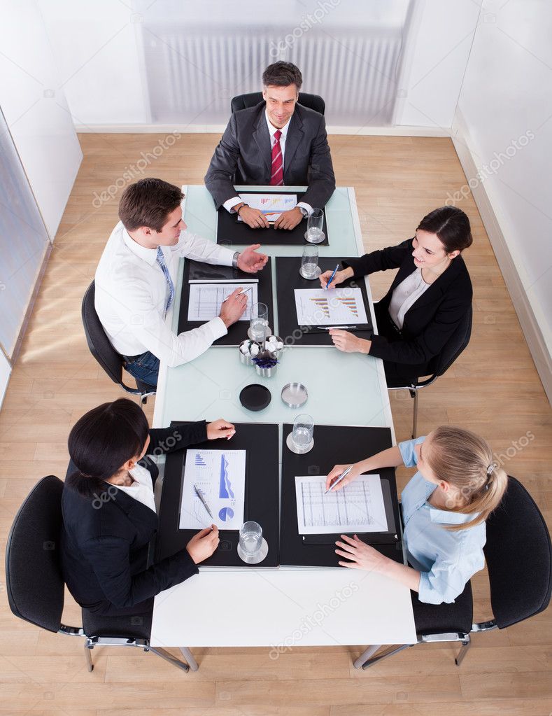 Businesspeople Sitting At Conference Table Stock Photo by ©AndreyPopov ...
