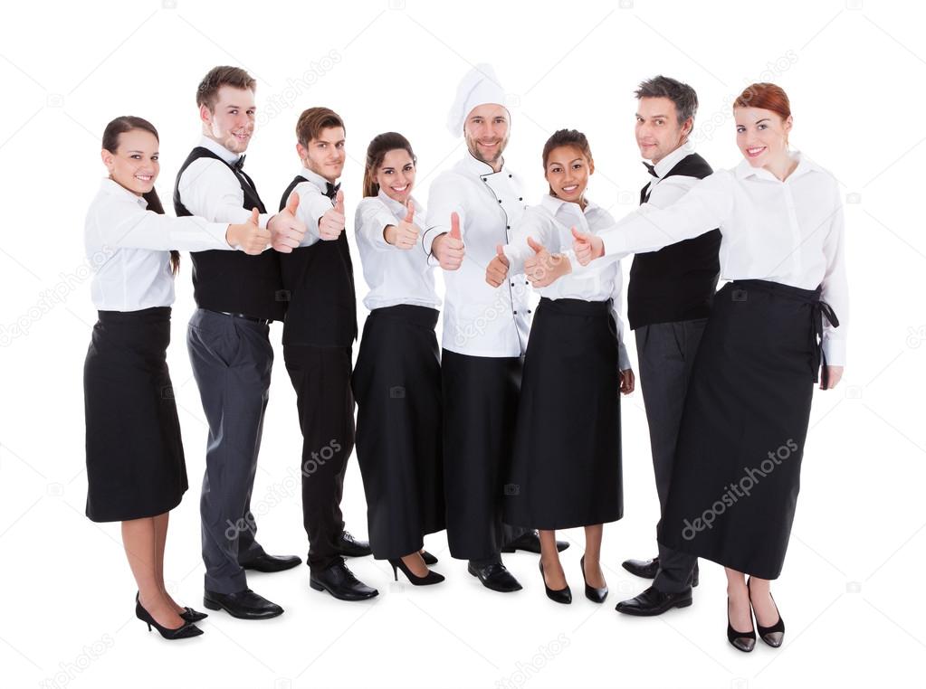 Waiters and waitresses showing thumbs up sign — Stock Photo ...